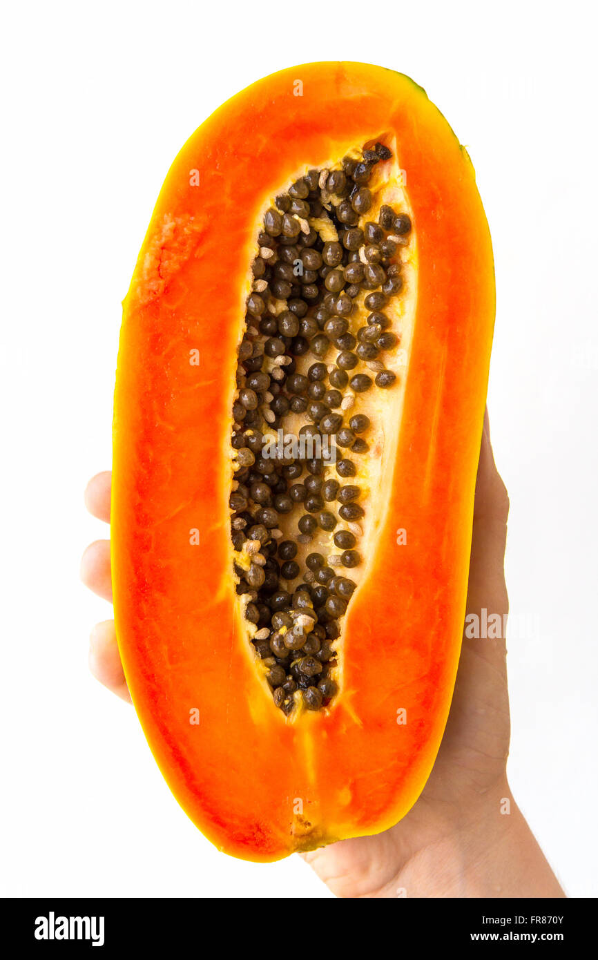 Half papaya on hand Cut Out Stock Images & Pictures - Alamy