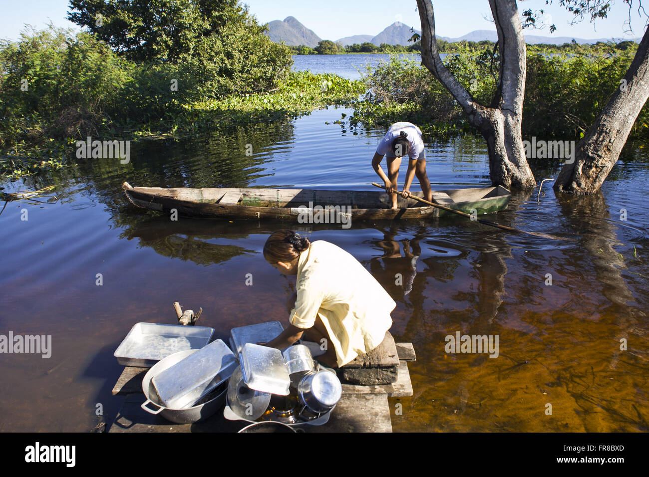 Riverside woman washing crazy on the River Paraguay Stock Photo - Alamy
