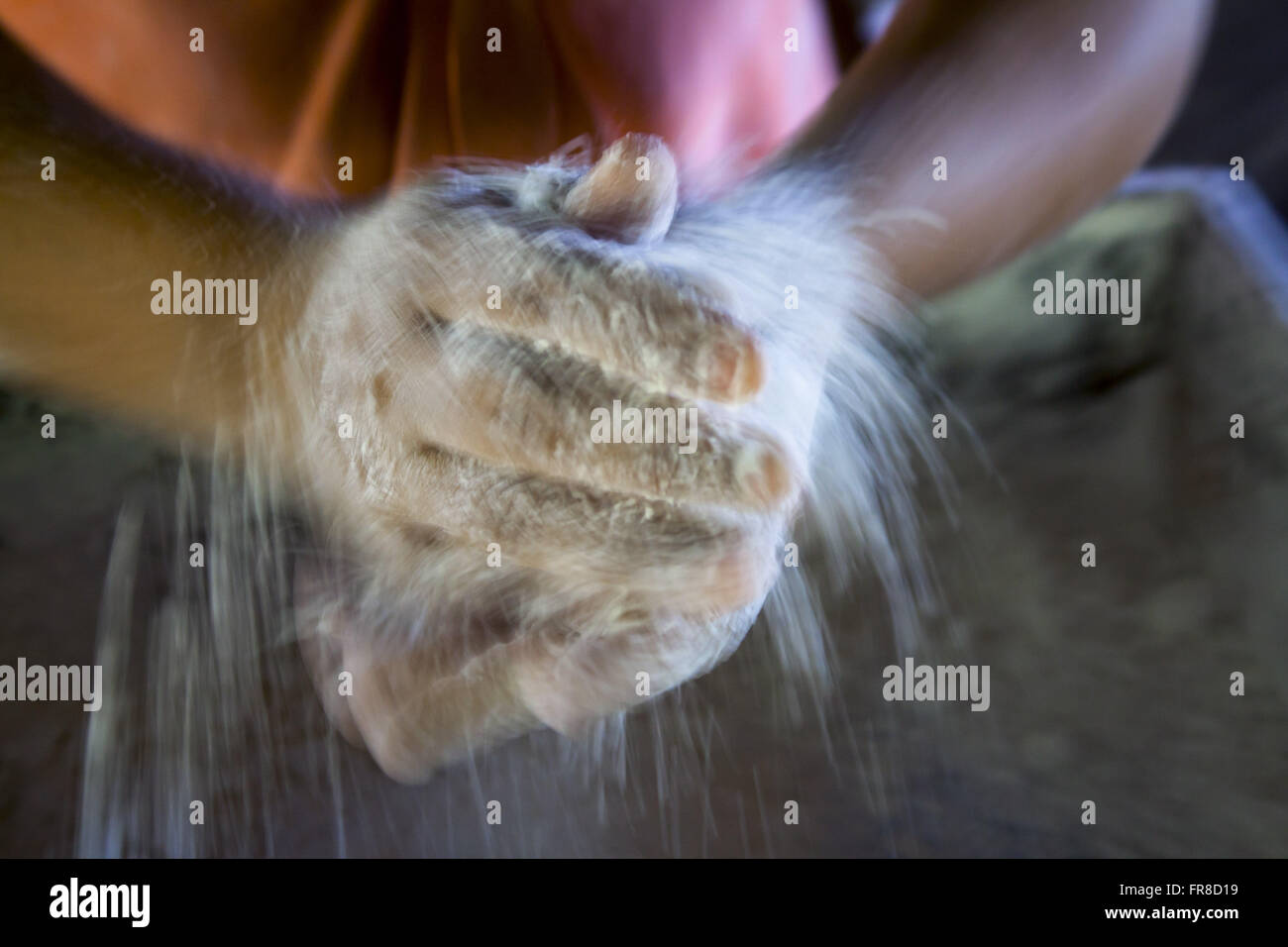 Hands crumble the manioc Stock Photo - Alamy