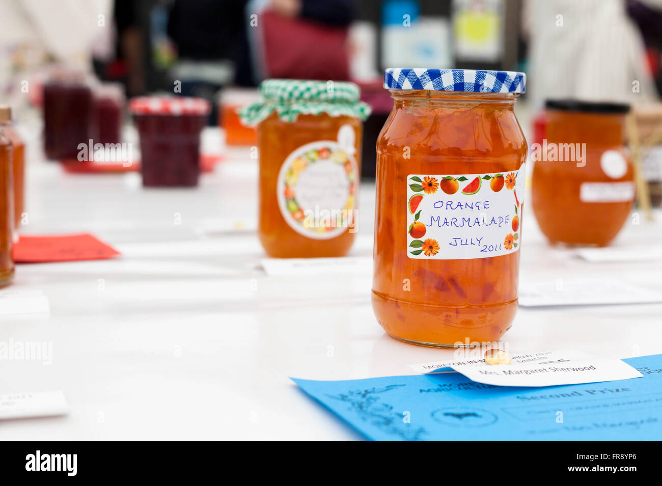A table display of home made jams, lemon curd and marmalde on show at a ...
