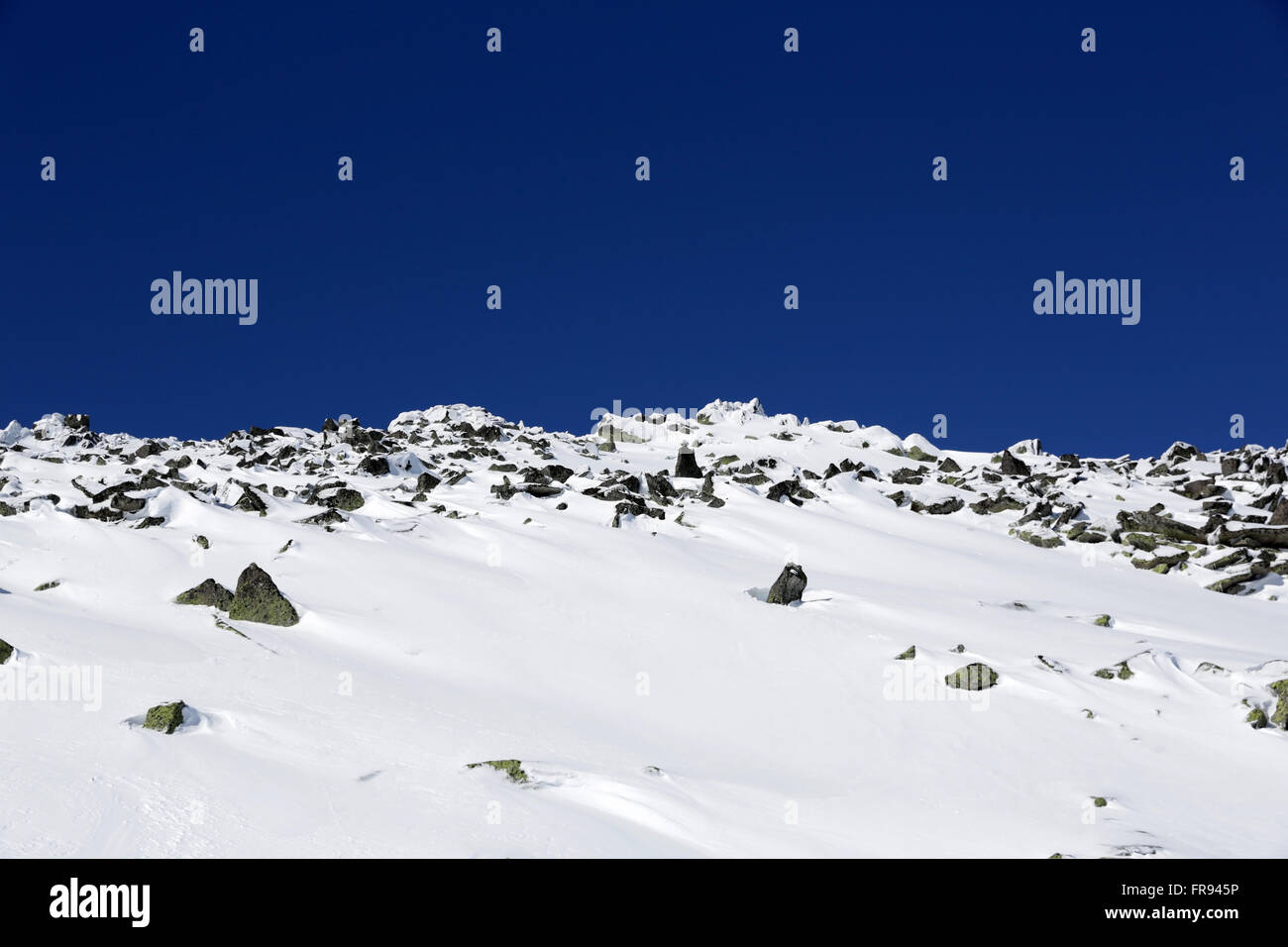 Rocky Virosha mountain top covered in snow against the clear blue sky ...