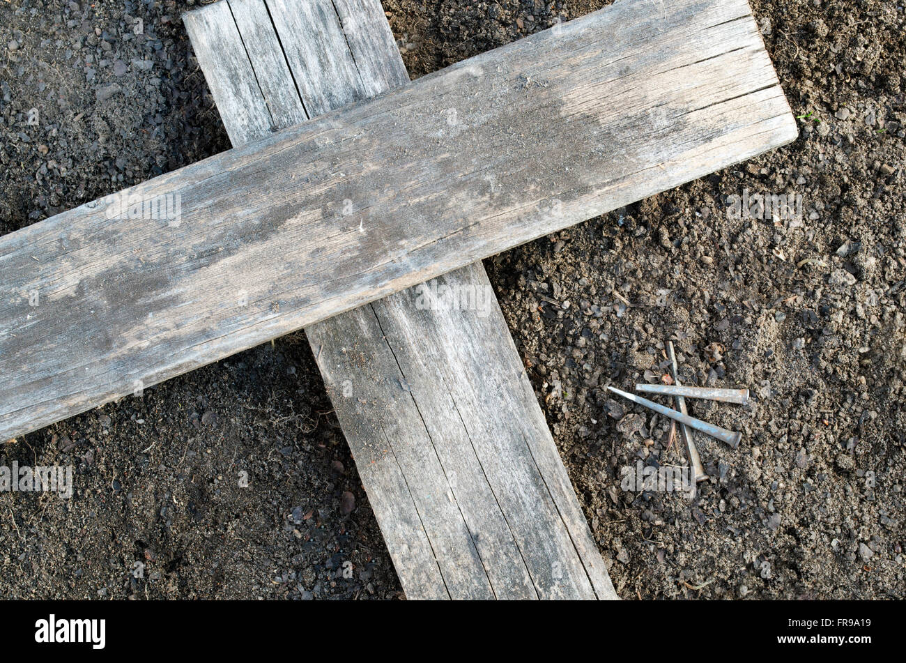 Wooden Cross laying on the ground with three nails nearby Stock Photo ...