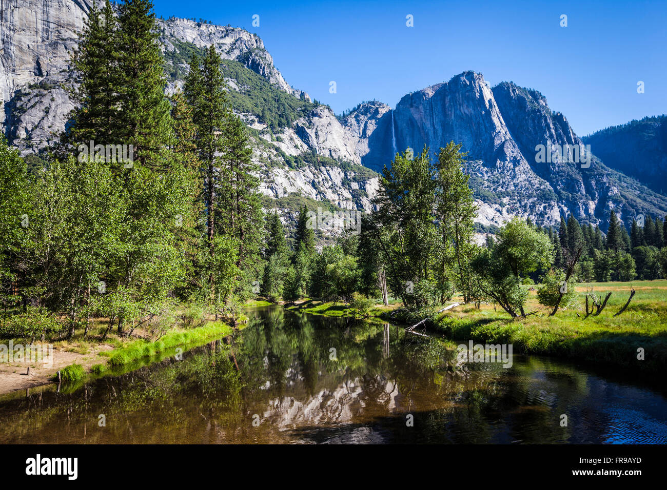 Merced river in Yosemite valley with mountains and waterfall on ...