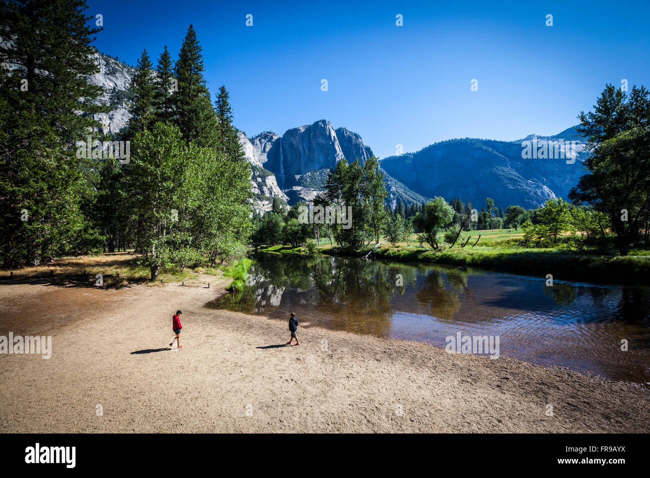 Merced river in Yosemite valley with mountains and waterfall on ...