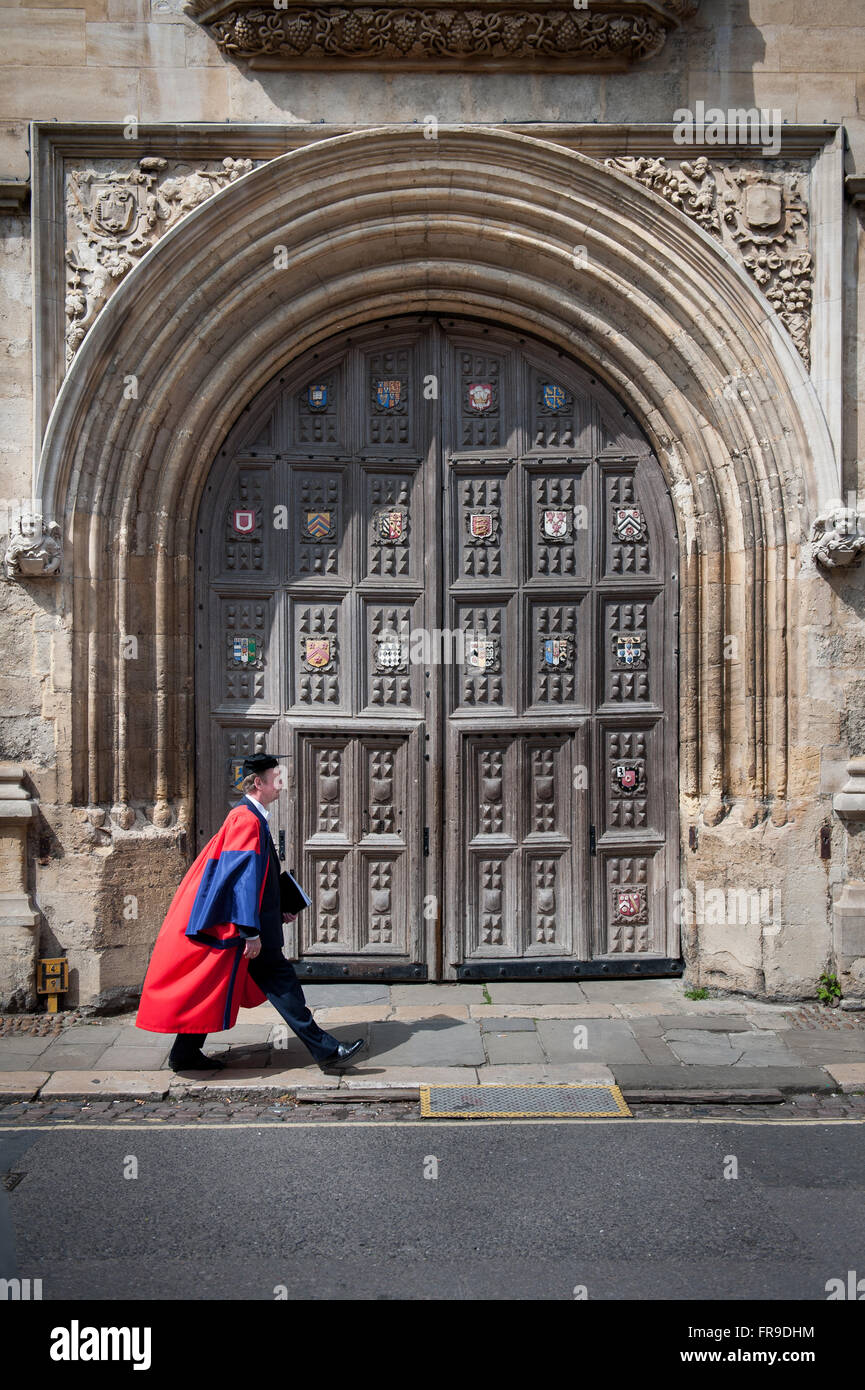 Oxford graduate wearing DPhil ceremonial gown walking past the Bodleian ...