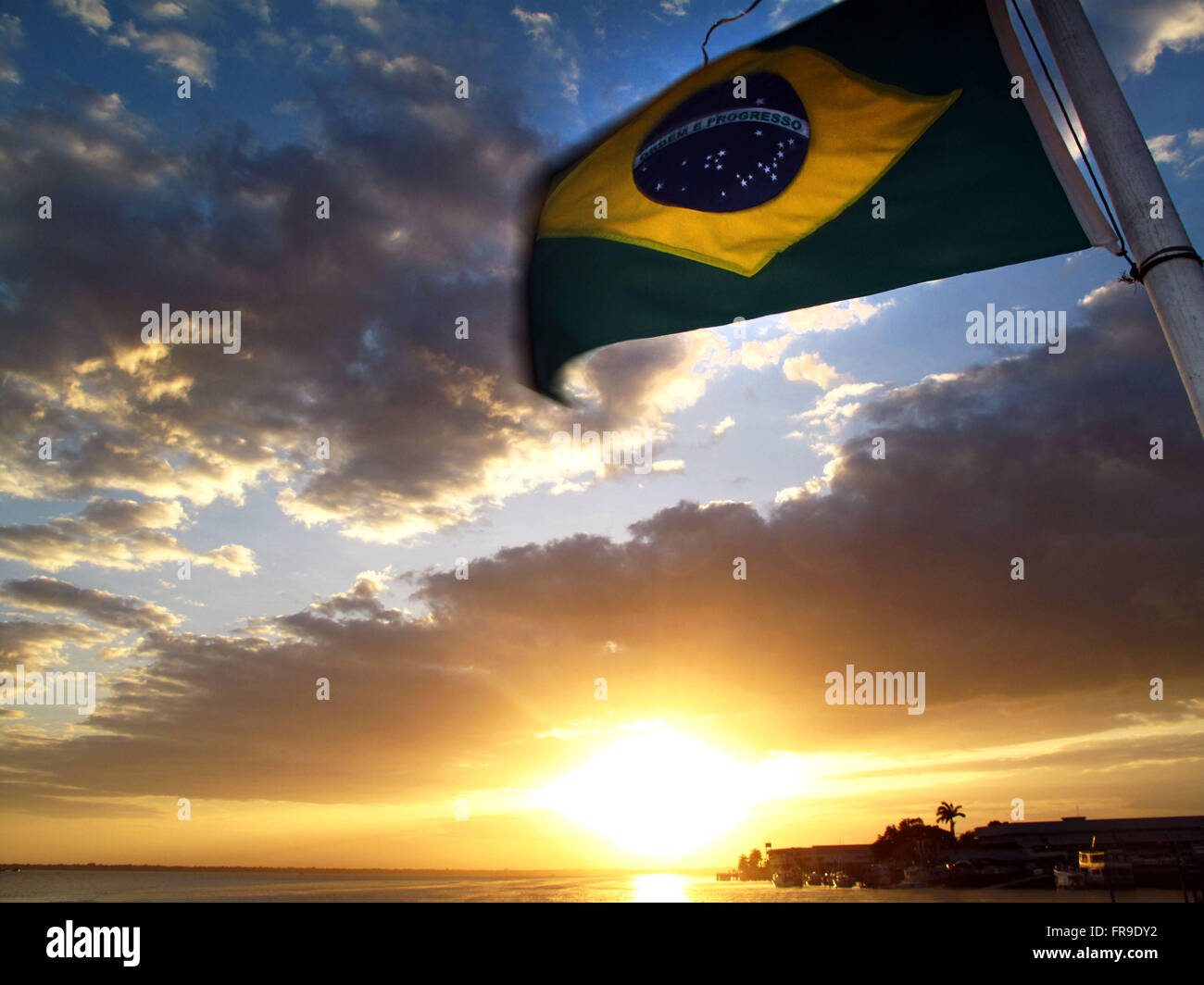 On-the-sun and mast with flag from Brazil on the Bay of Guajara city of ...