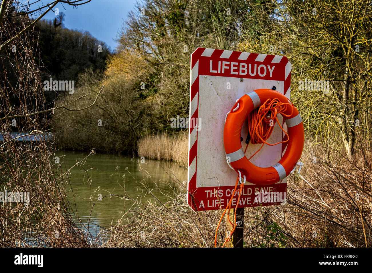 Lifebuoy and sign by lake Stock Photo - Alamy