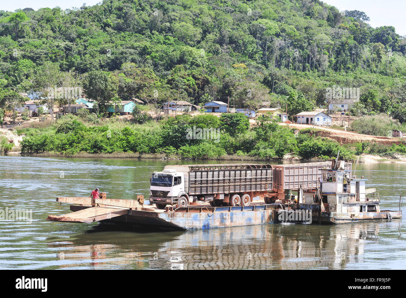 Ferry crossing the River Aripuana river community with houses in the ...