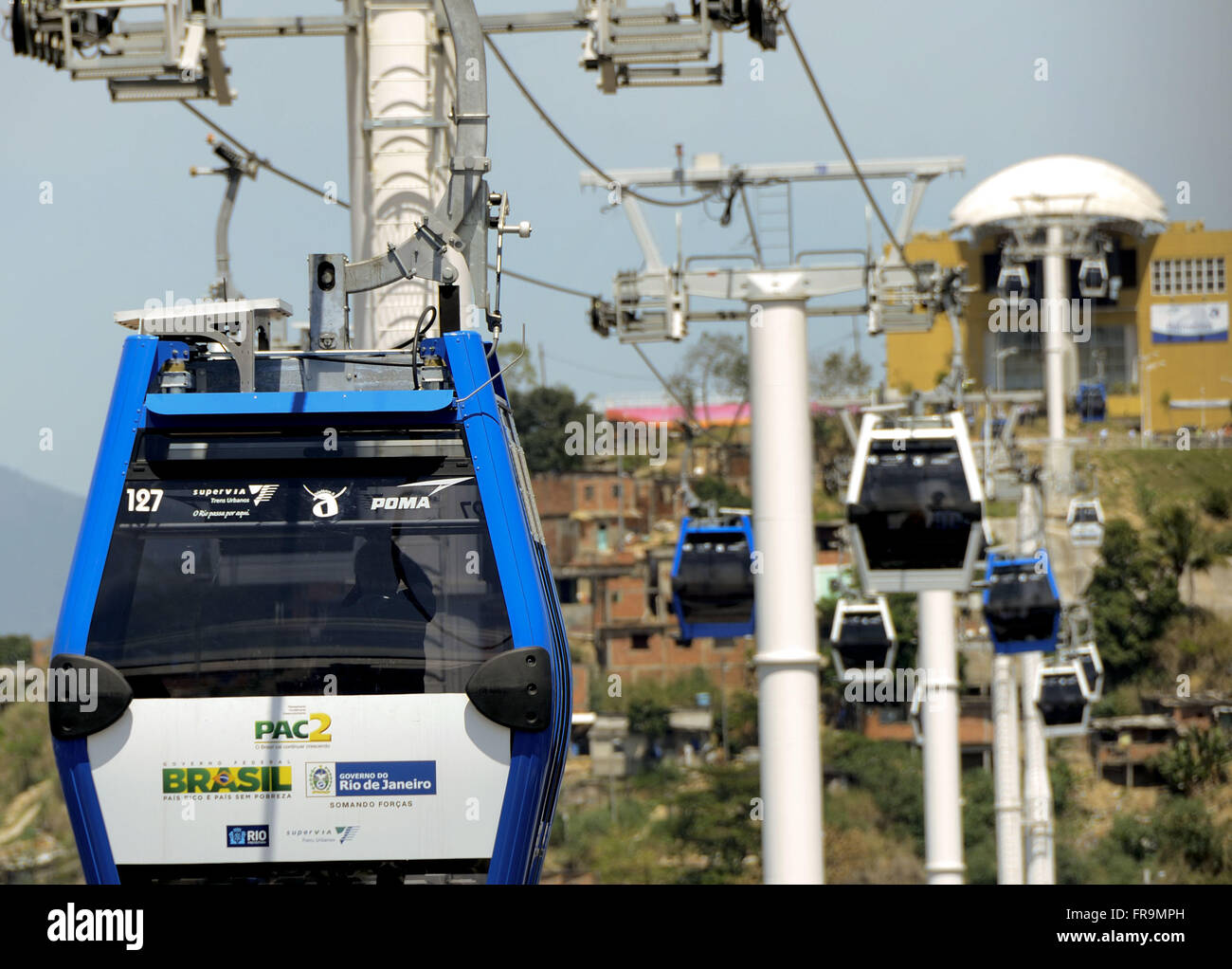 Green palm trees of Complexo do Alemao cable car - set of 13 slums in ...