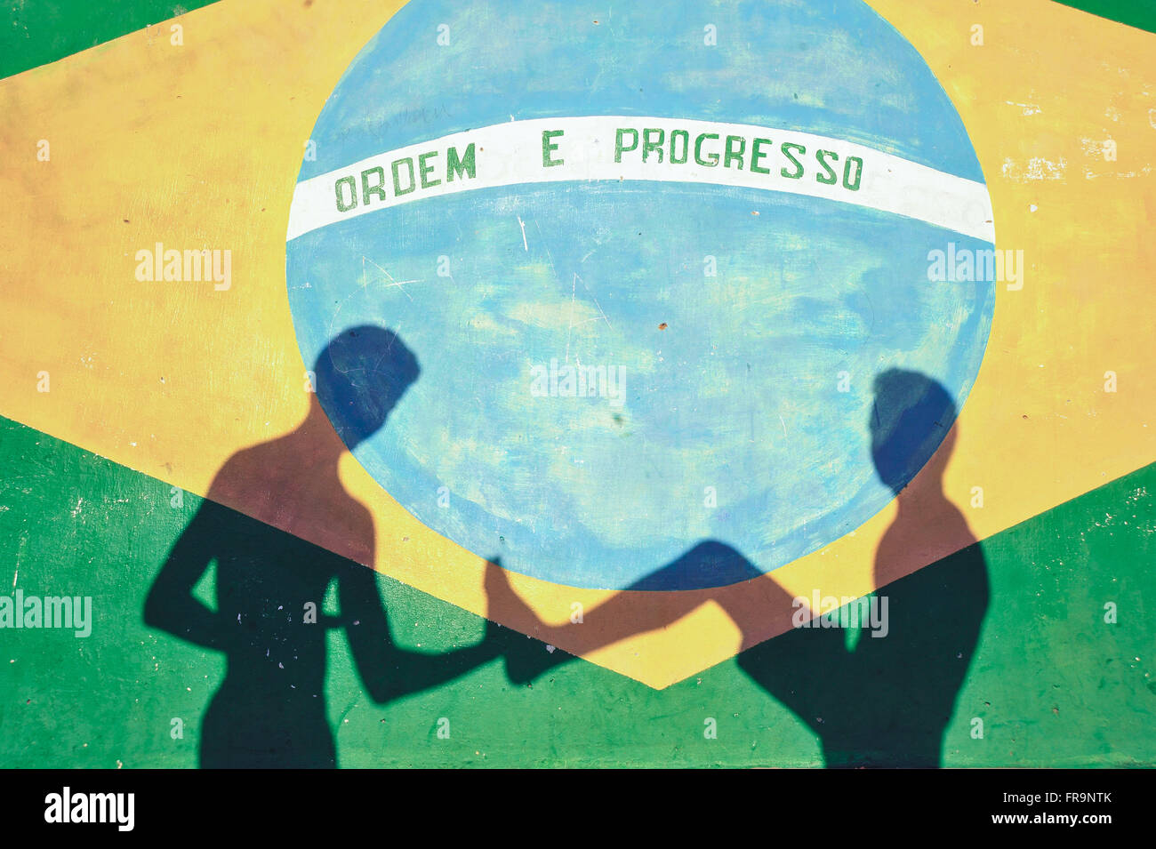 Shadow of people playing capoeira with wall painting of the national ...