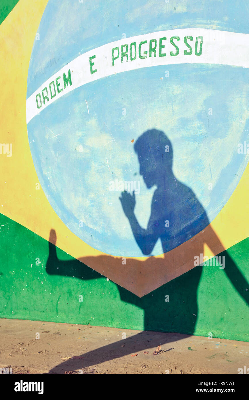 Shadow of people playing capoeira wall with painting of the national ...
