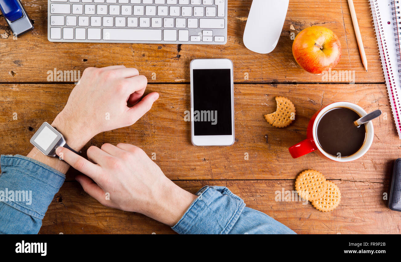 Business person working at office desk wearing smart watch Stock Photo ...