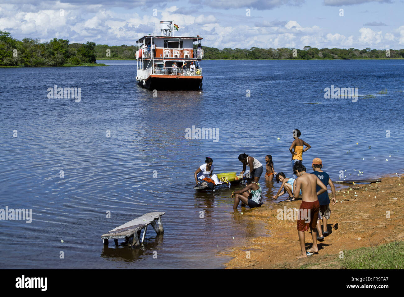 People on the river and Guapore vessel crossing the bottom Stock Photo ...