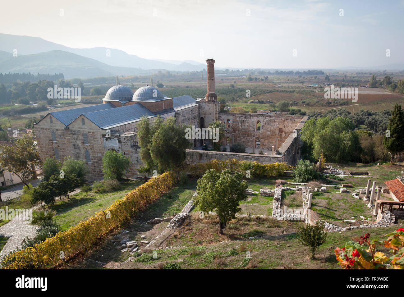 A minaret at a mosque and landscape with mountains in the distance ...