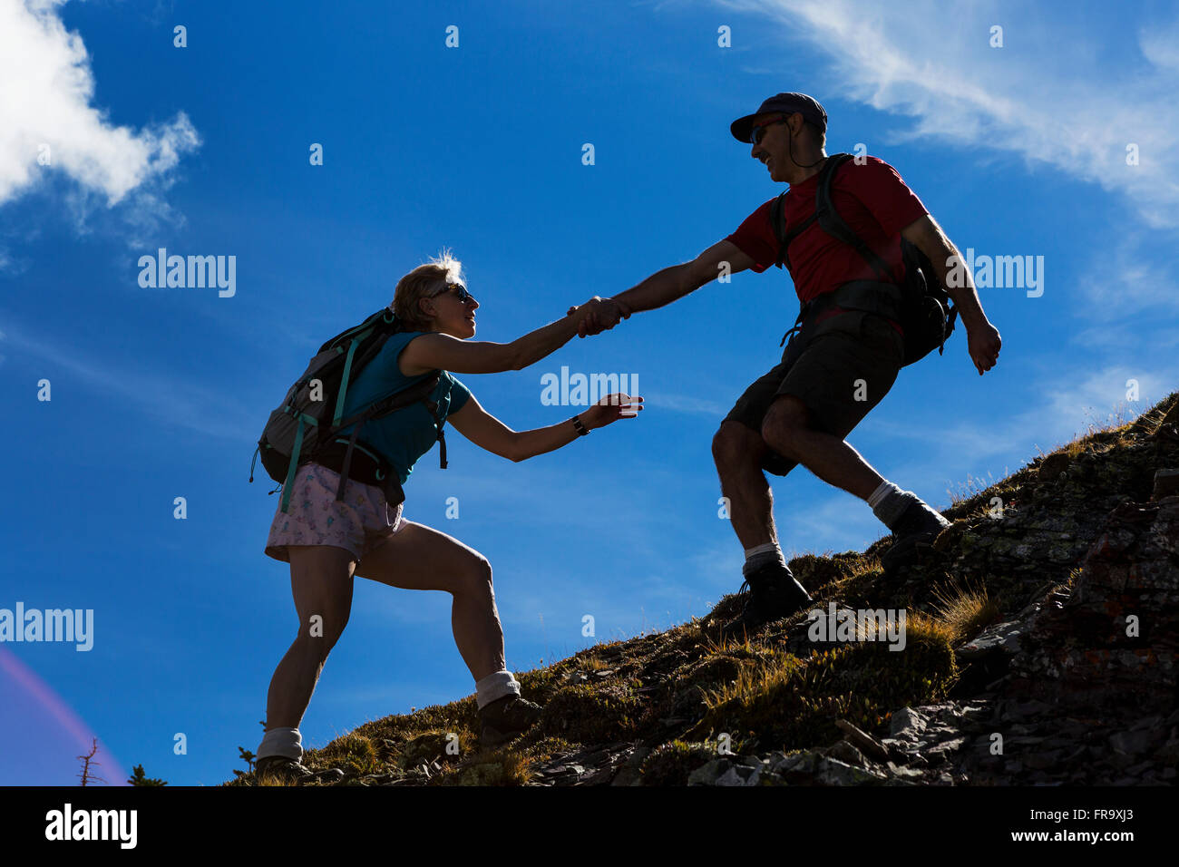 Helping hand couple hiker hi-res stock photography and images - Alamy