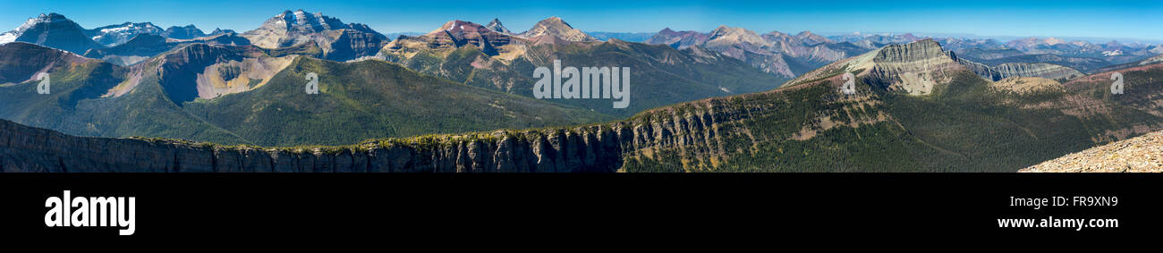 Panorama of mountain range with blue sky; Waterton, Alberta, Canada ...