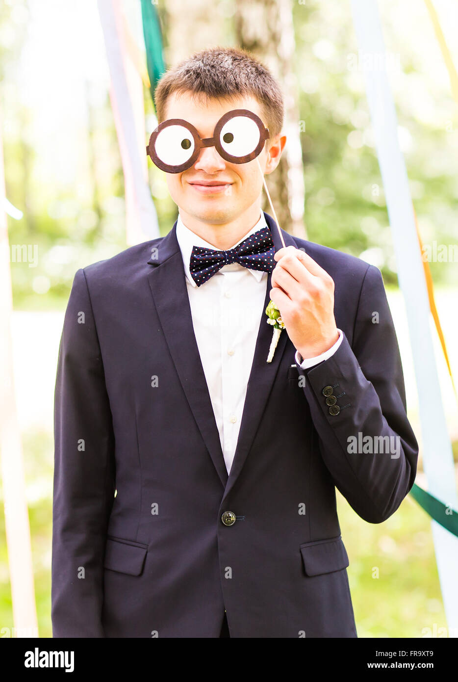 April Fools' Day. Wedding couple have fun with mask Stock Photo - Alamy