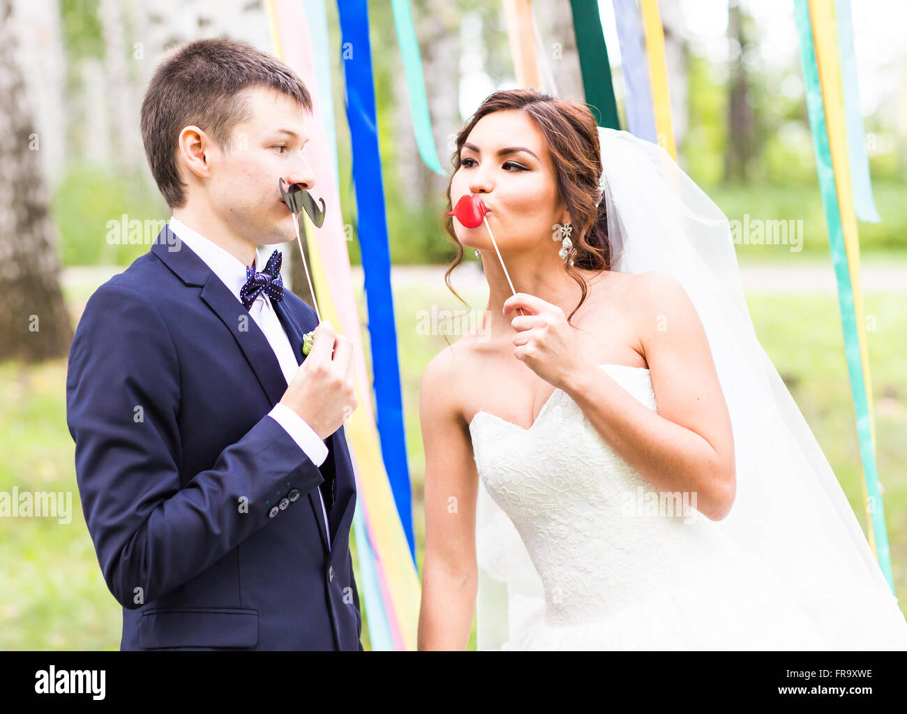 April Fools' Day. Wedding couple posing with mask Stock Photo - Alamy