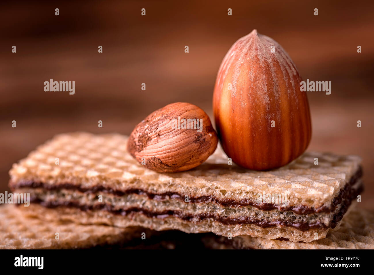 wafer and hazelnut on wood Stock Photo - Alamy