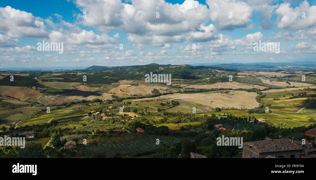 Landscape of rolling hills under a blue sky with cloud; Montepulciano ...