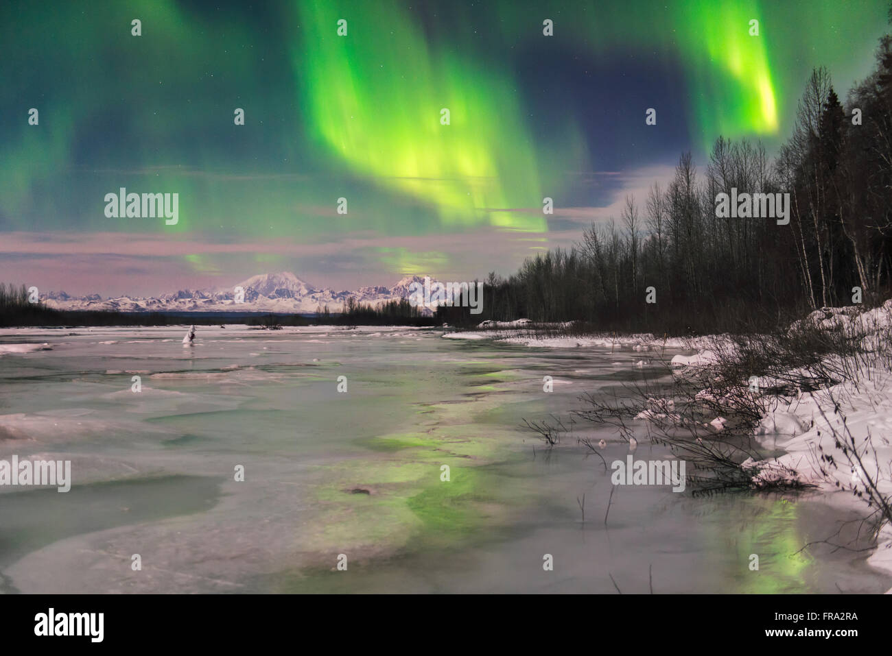 Aurora borealis over frozen Susitna River with Mt. Foraker and Mt ...