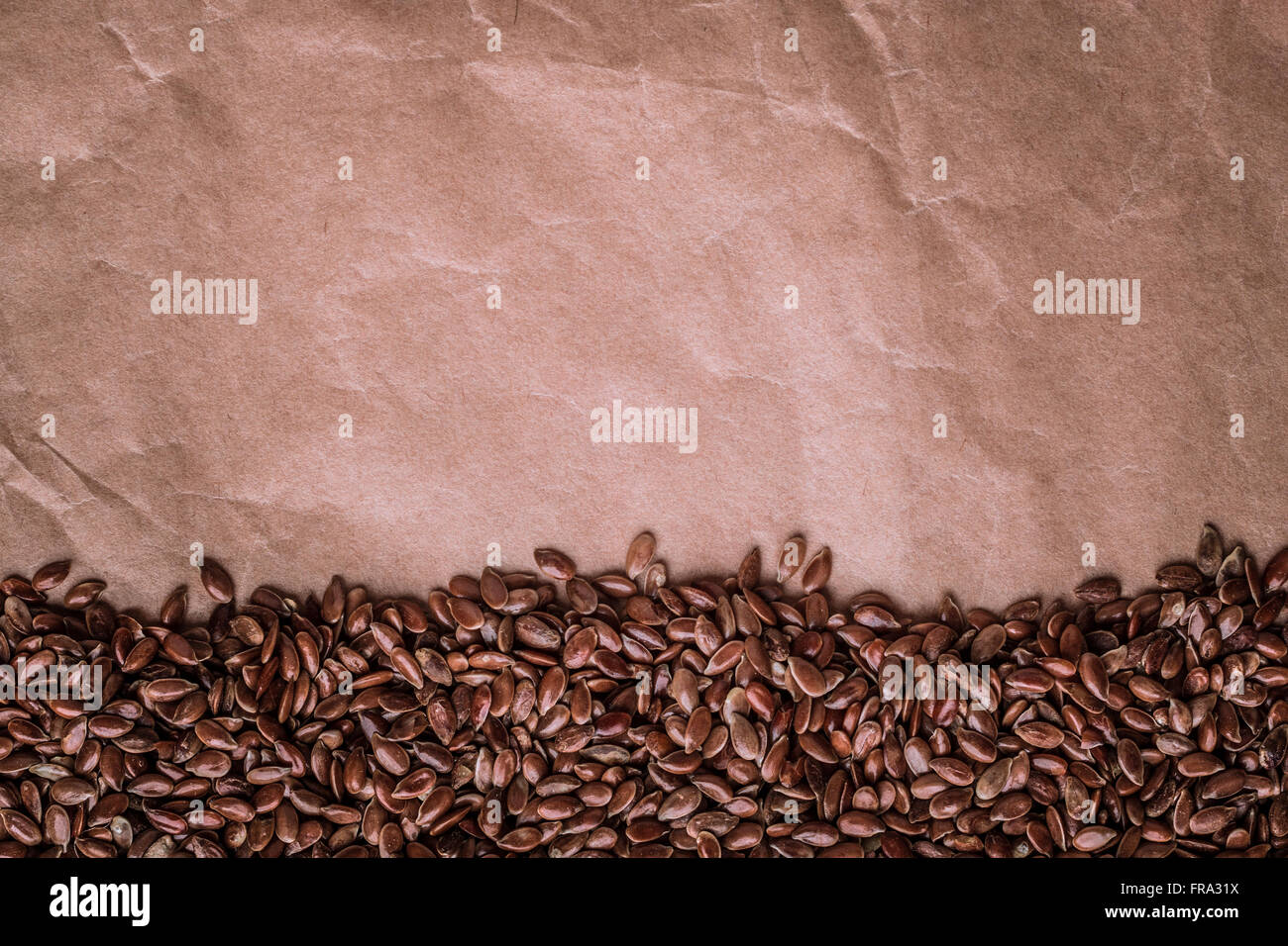 Healthy diet organic nutrition. Brown raw flax seeds linseed border frame on paper background ...