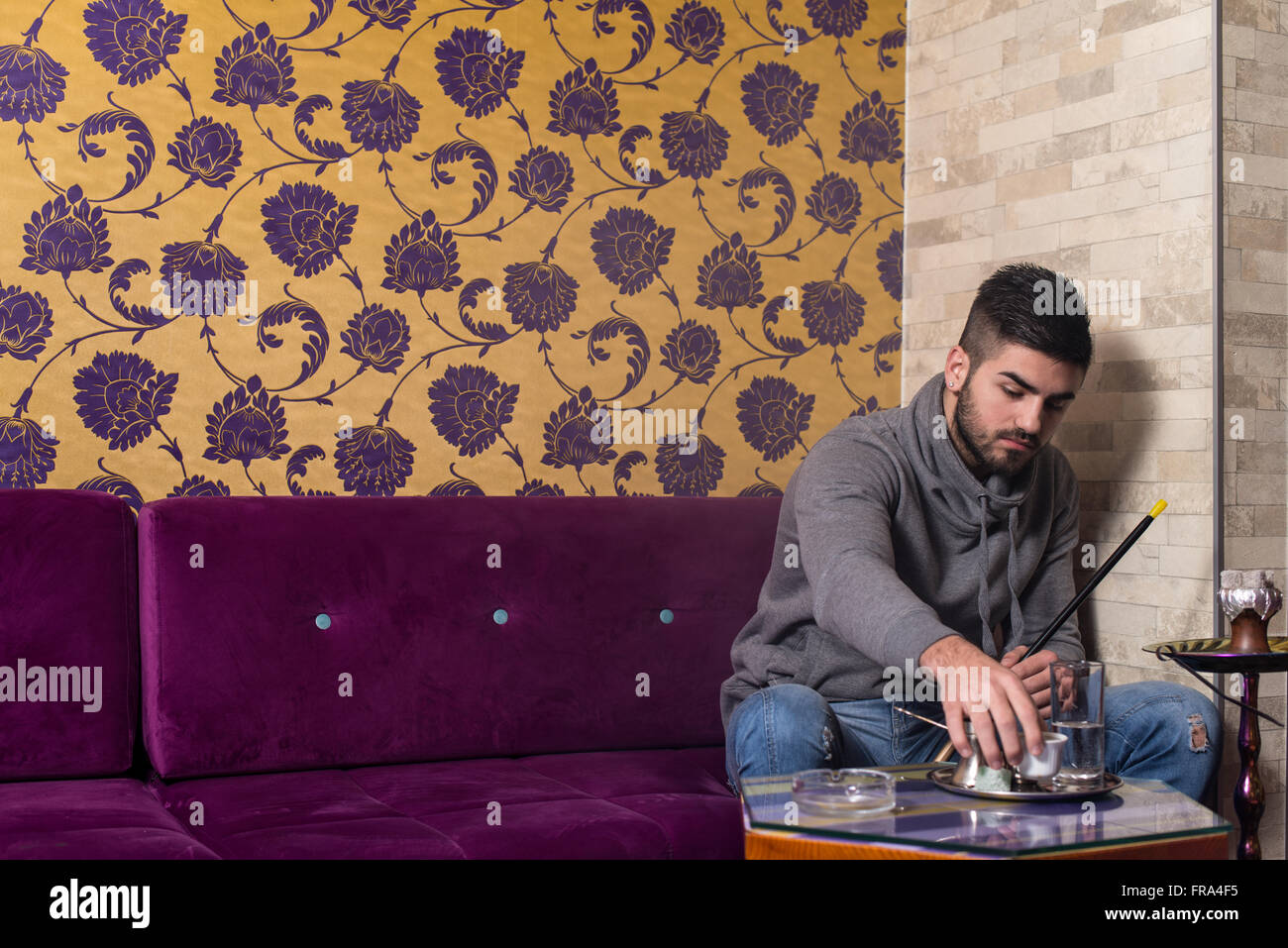 Man Smoking Turkish Hookah In The Cafe With Colorful Walls On ...