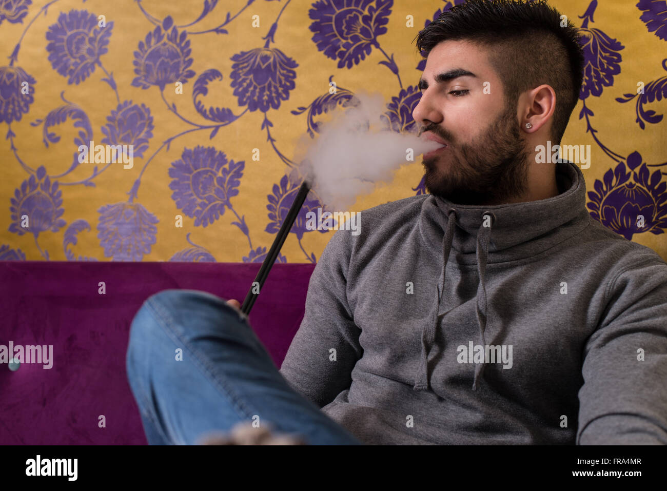 Man Smoking Turkish Hookah In The Cafe With Colorful Walls On ...