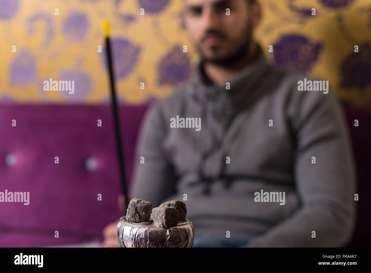 Young Man Smoking Shisha At Arabic Restaurant - Man Exhaling Smoke ...