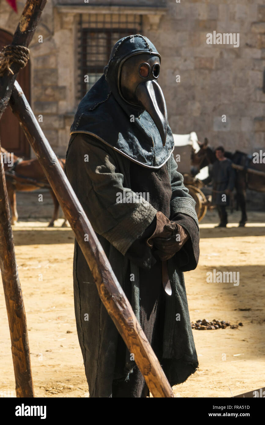 Man dressed in medieval costume with a mask to cover his face ...