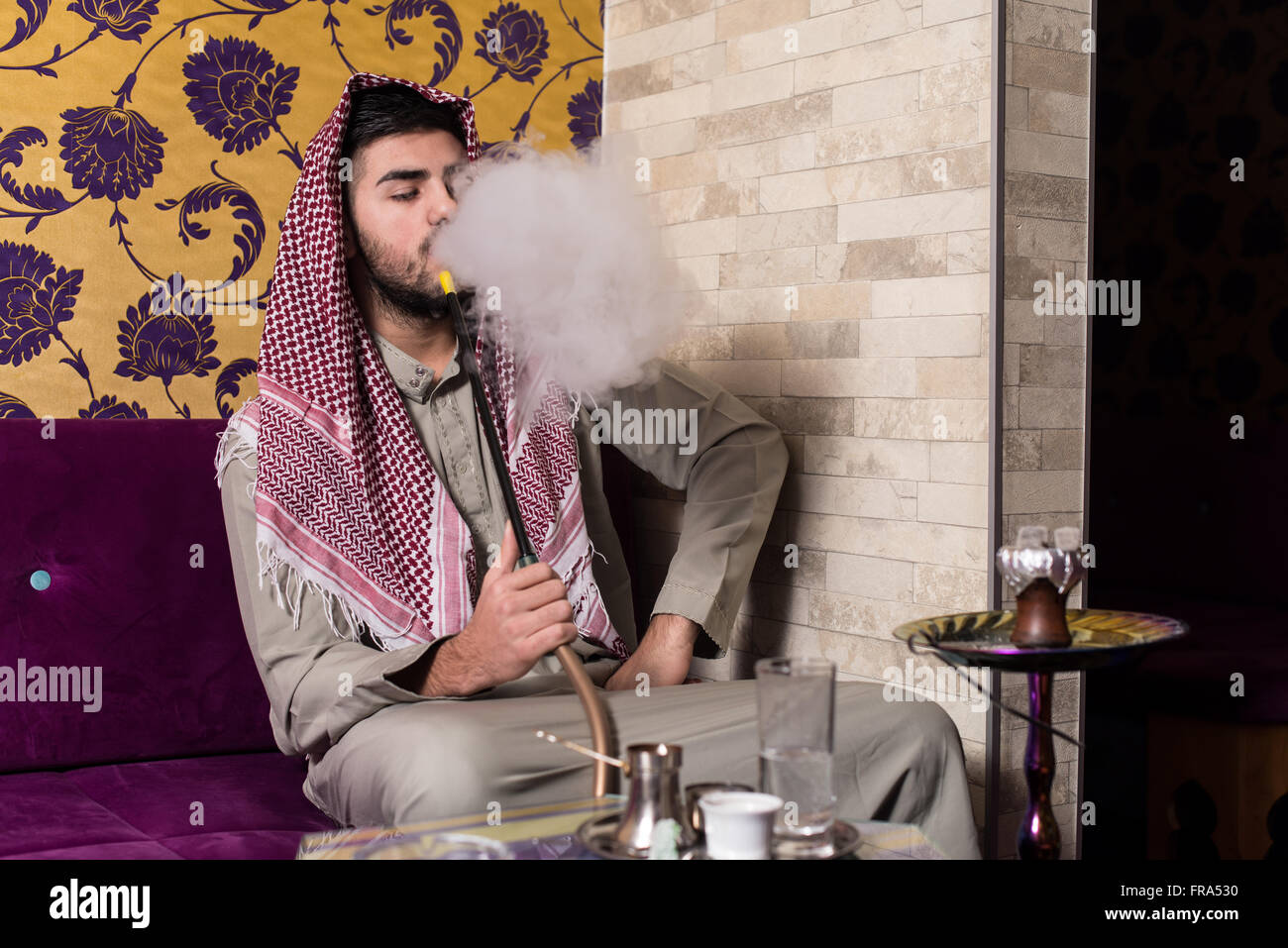 Arab man smoking shisha on hi-res stock photography and images - Alamy