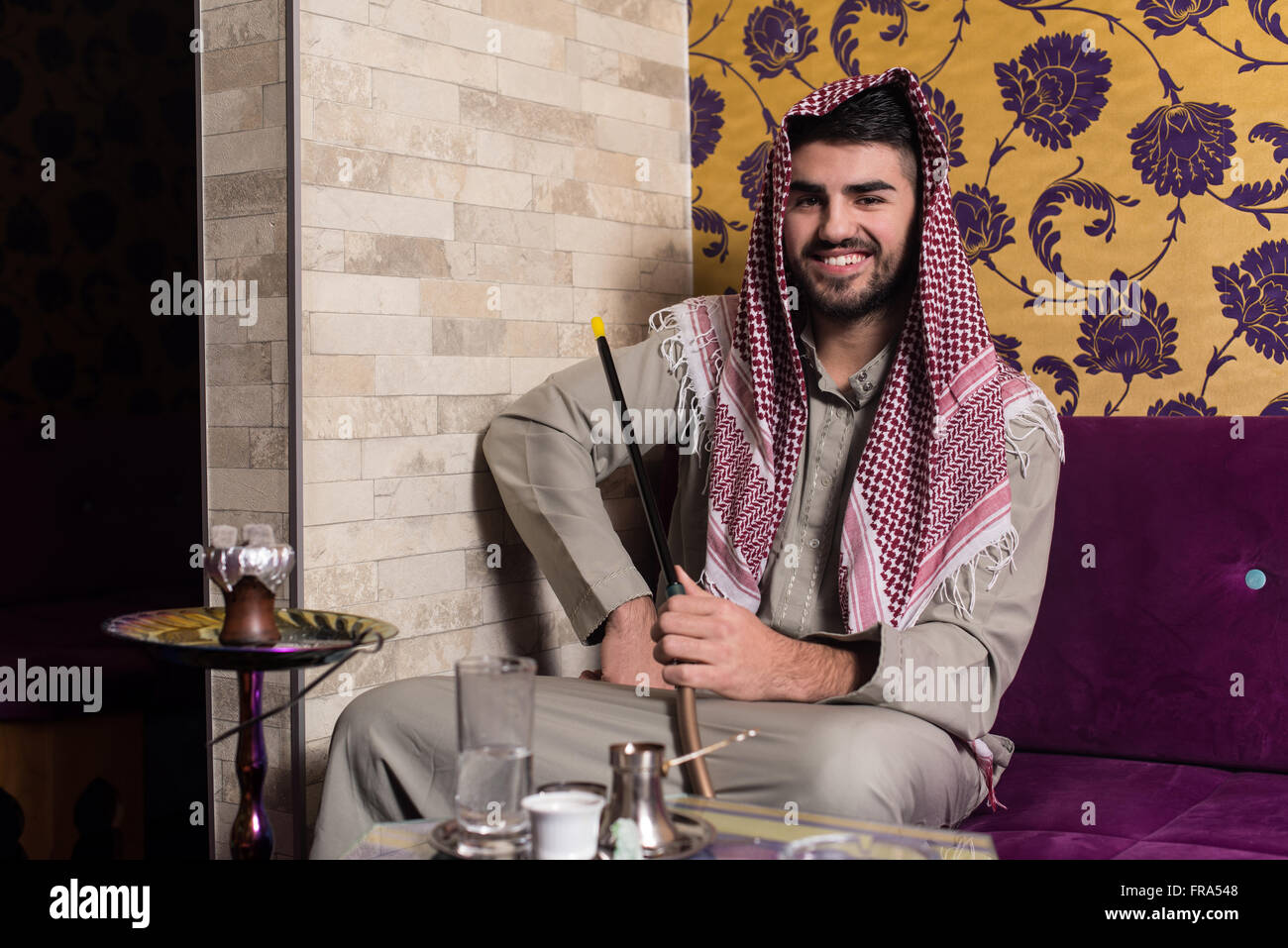 Muslim Man Smoking Shisha At Arabic Restaurant - Exhaling Smoke Stock ...