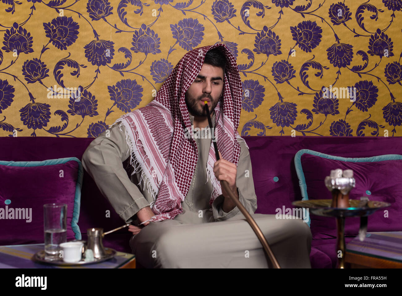 Muslim Man Smoking Shisha At Arabic Restaurant - Exhaling Smoke Stock ...