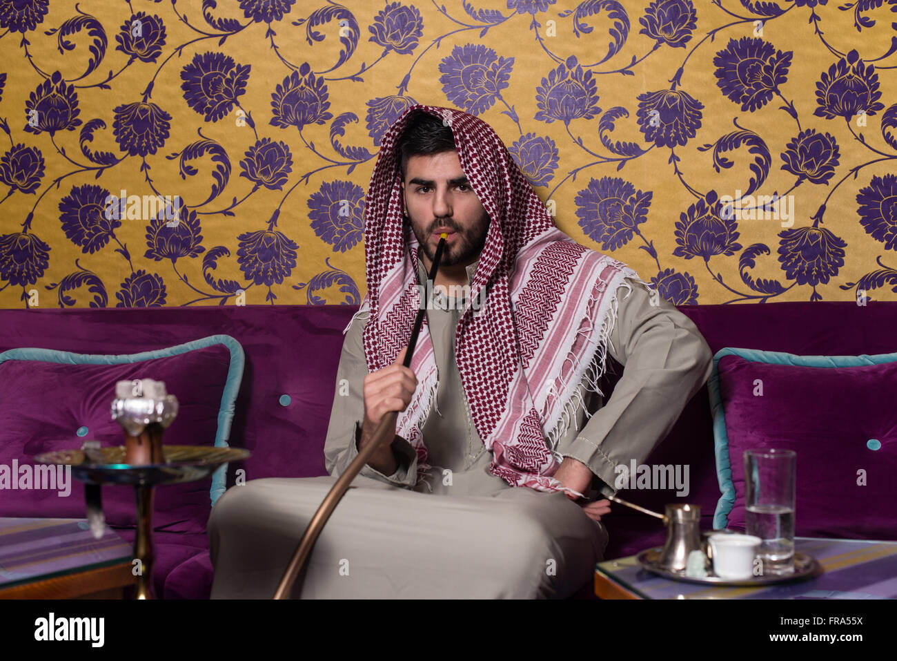 Muslim Man Smoking Shisha At Arabic Restaurant - Exhaling Smoke Stock ...