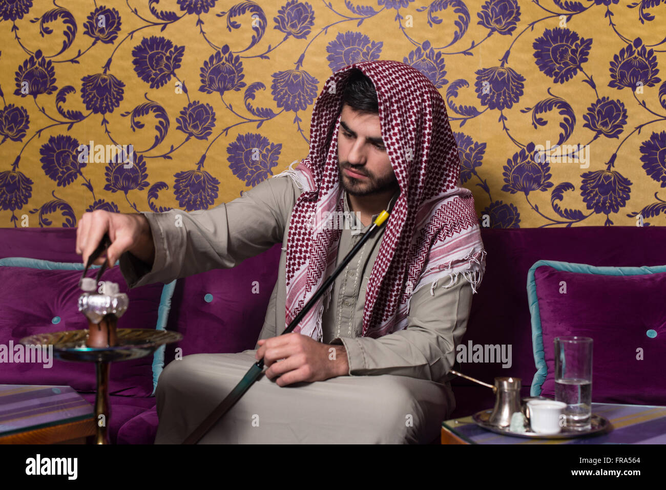 Young Saudi Arabian Man Smoking Arabic Hubble Bubble Hookah, 60% OFF