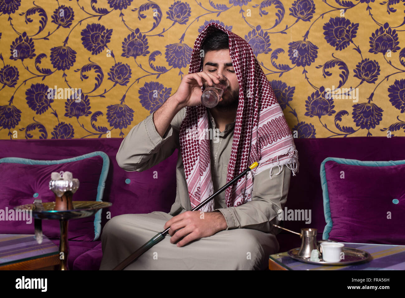 Muslim Man Smoking Shisha At Arabic Restaurant - Exhaling Smoke Stock ...