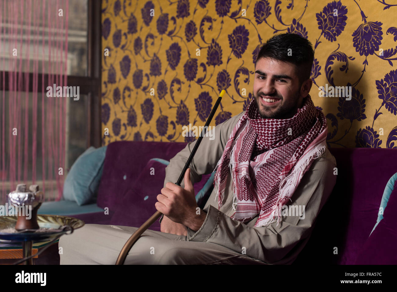 Islamic Man Smoking The Traditional Hubble-Bubble Or Hookah While ...