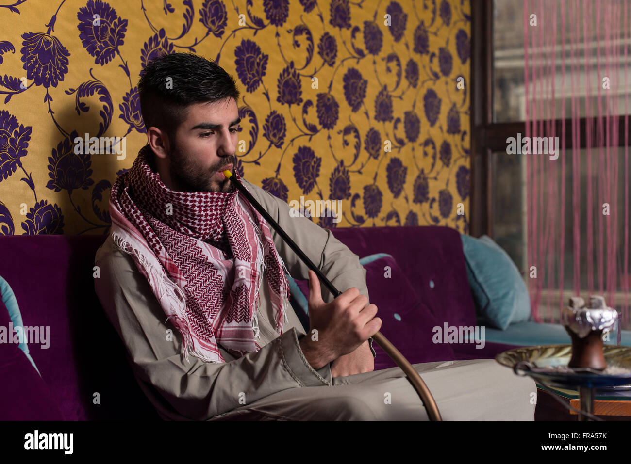Muslim Man Smoking Shisha At Arabic Restaurant - Exhaling Smoke Stock ...