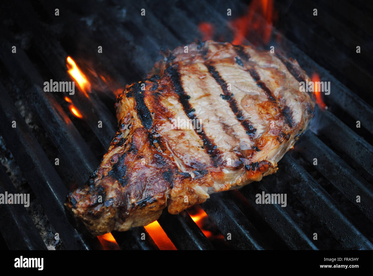 Flame Grilling a Lean Beef Steak on the Grill Stock Photo - Alamy