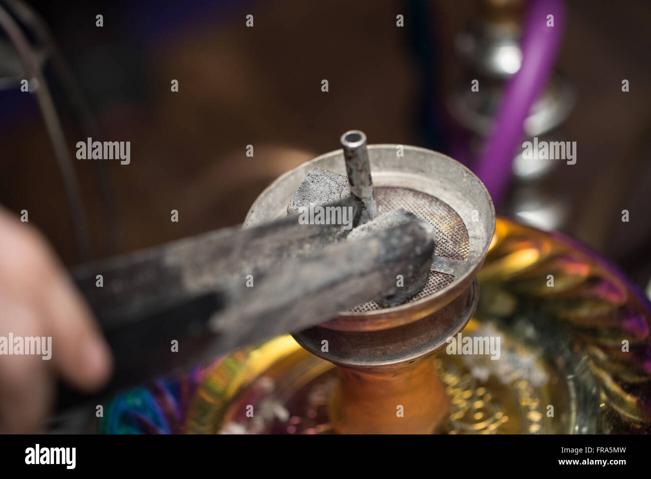 Preparation The Hookah With Charcoal For Smoking The Traditional Hubble ...