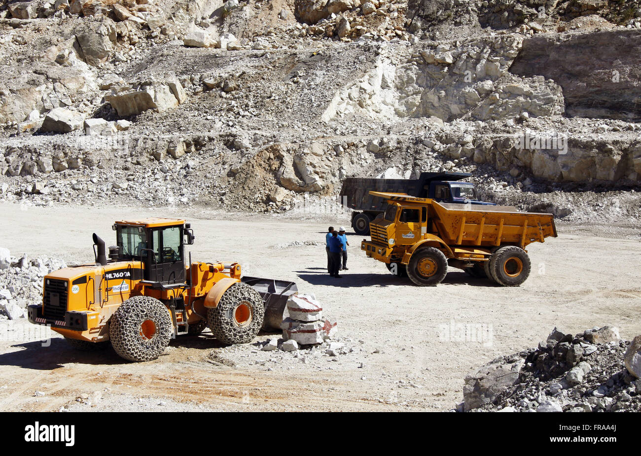 Machines working on mine limestone in the open sky - municipality of ...