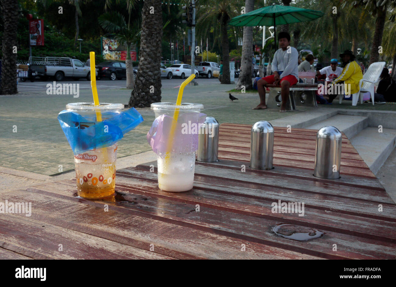 Two discarded plastic drink containers left on a public bench in ...