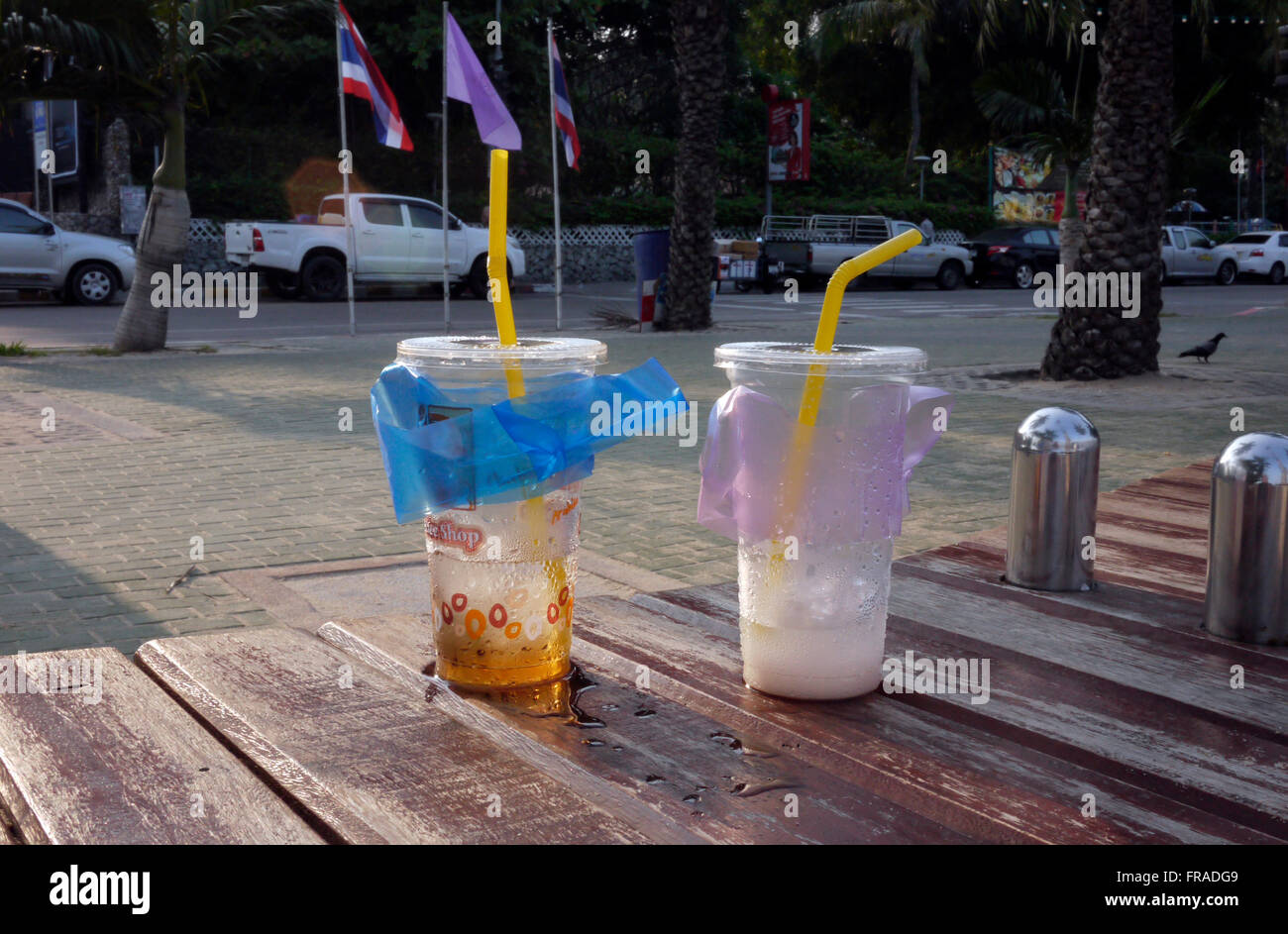 Two discarded plastic drink containers left on a public bench in ...