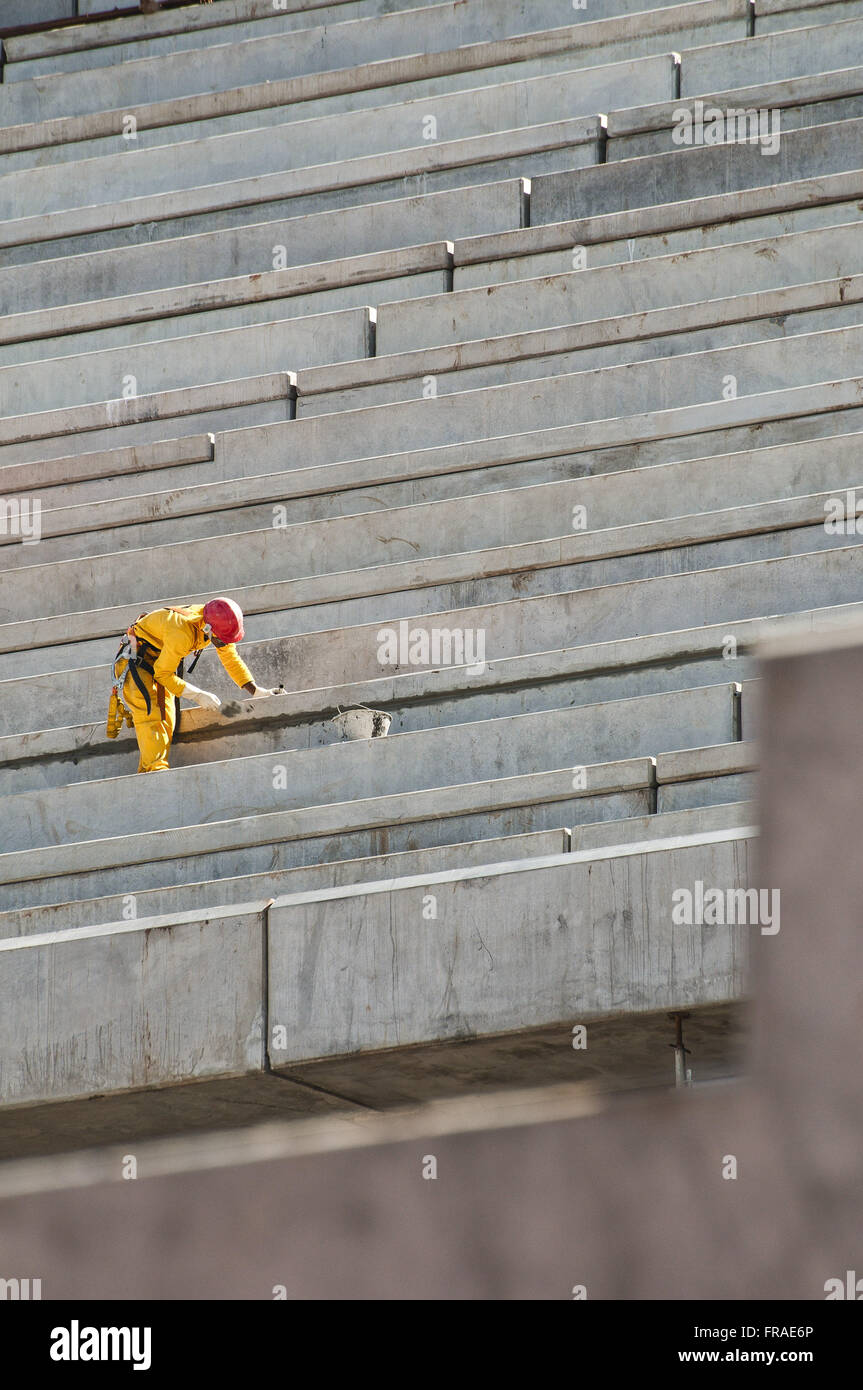 Laborer works in the stands - Construction of multipurpose arena ...
