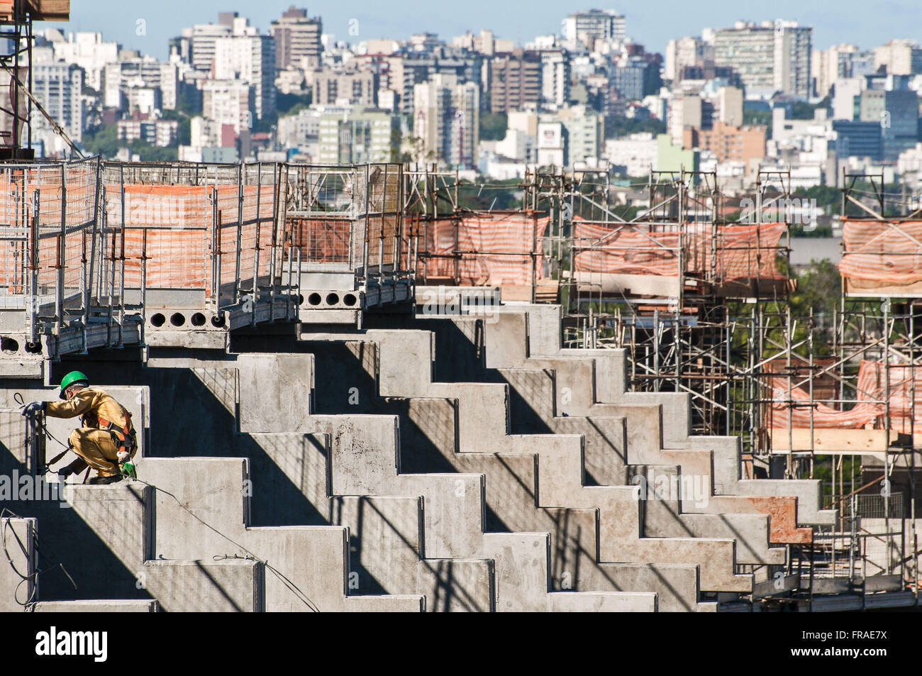 Laborer works in the stands - Construction of multipurpose arena ...