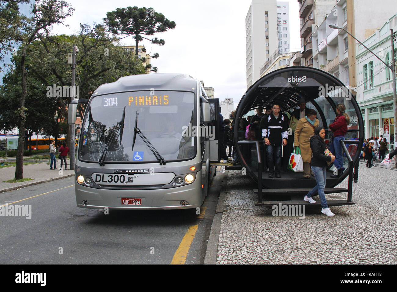 Passengers disembarking from urban bus tubular season Stock Photo - Alamy