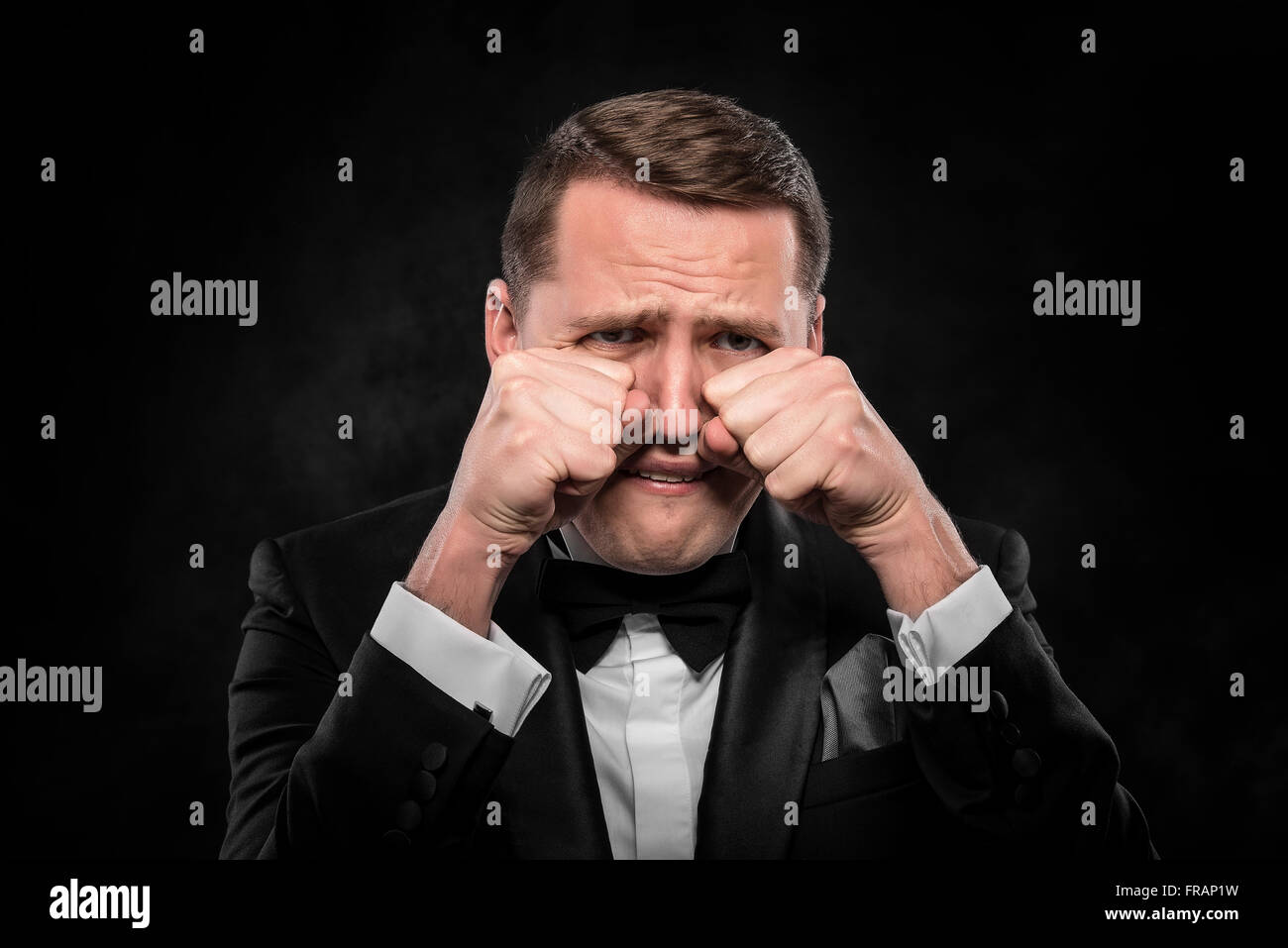 Man in suit crying Stock Photo - Alamy