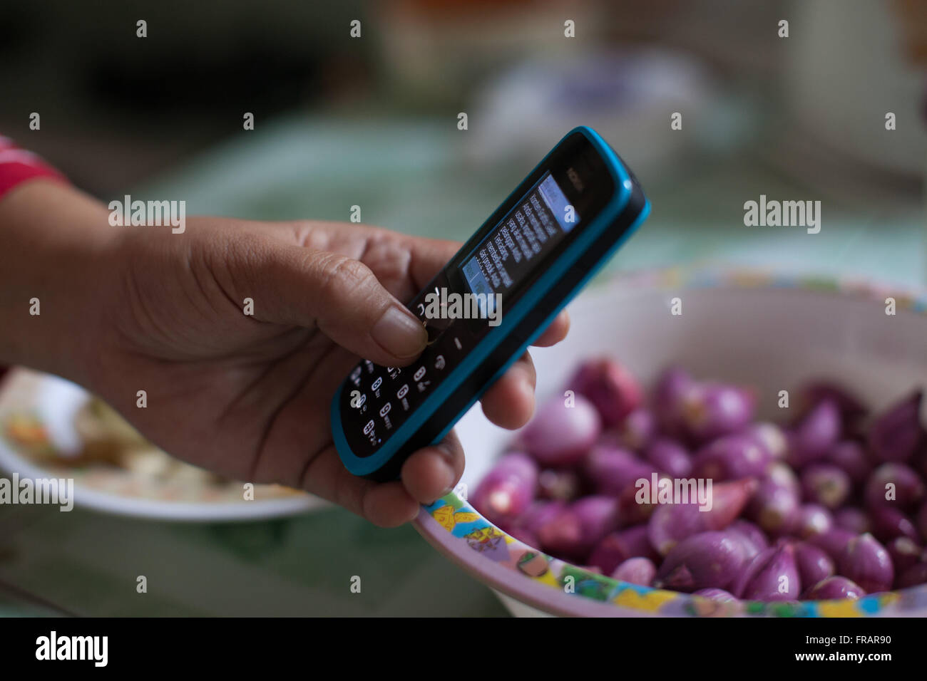A woman holding her mobile phone, Indonesia, Asia Stock Photo - Alamy