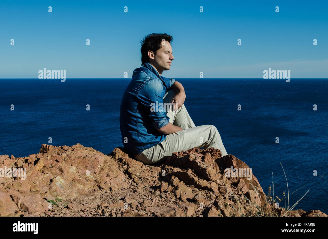 A man thinking and looking at the horizon Stock Photo - Alamy