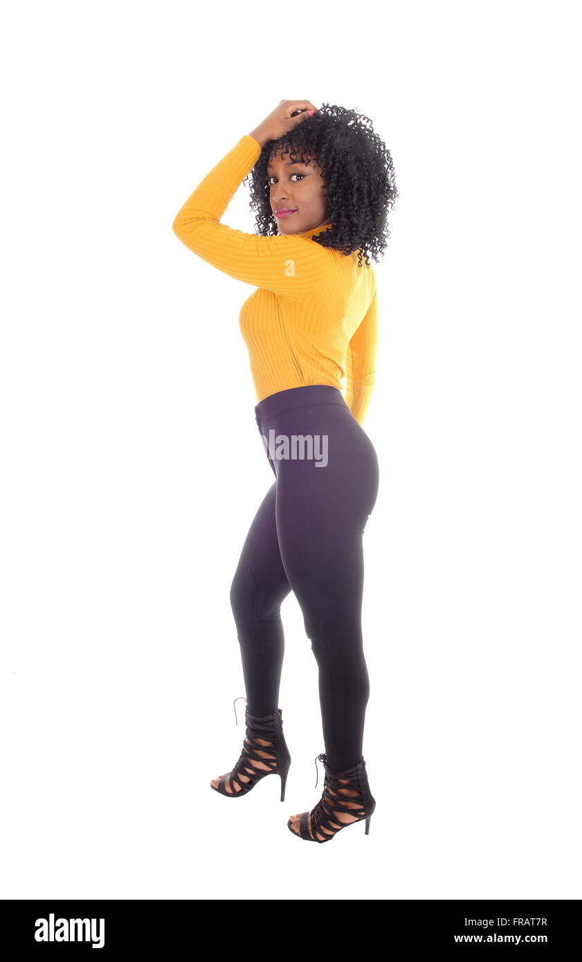 A Beautiful African American Woman In Black Tights And Yellow Sweater